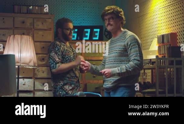 Two funny Caucasian friendly men nerds in glasses and old style clothes ...