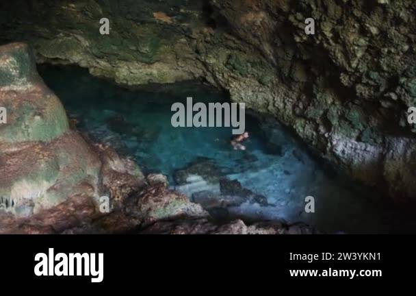 Young Woman Swims in an Underground River in Cave with Fresh Water ...