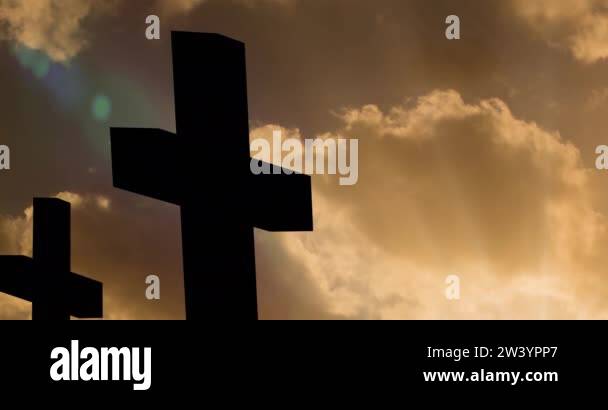 Animation of three christian crosses over sun shining on yellow sky ...