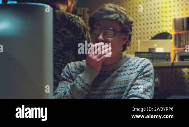 Caucasian man in glasses and retro style smoking cigarette in front of ...