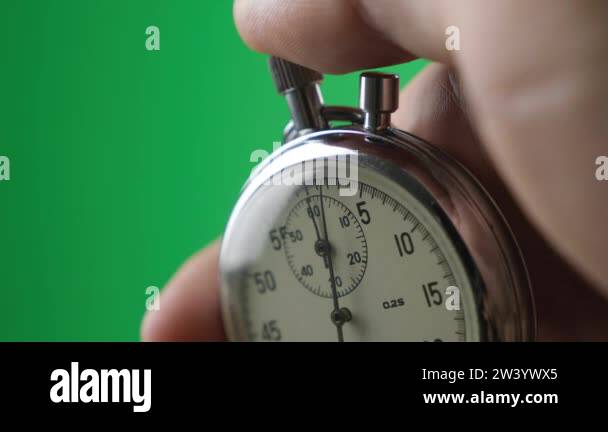 Male hand holding analogue stopwatch on green screen chroma key. Time ...