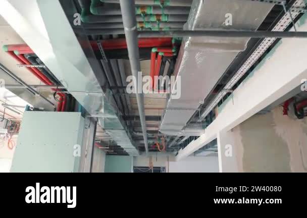 Pipes and ventilation on the ceiling of the building corridor ...