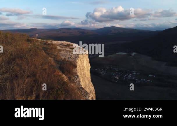 Peaceful natural background with a cliff edge and a village located ...