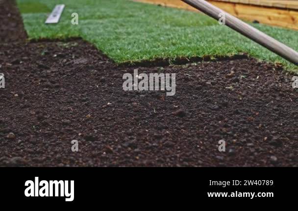 Gardener Grading Out Soil With A Rake. SLOW MOTION. Unrecognizable ...