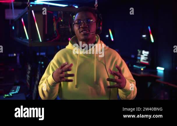 A dark-skinned commentator of esports matches leads a live broadcast ...