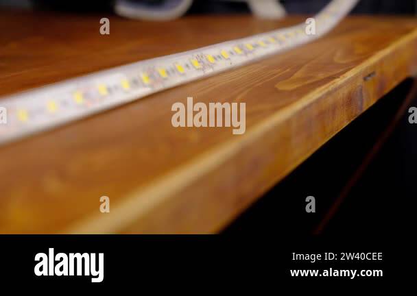 installation of LED light on the work surface, the master tries on the ...