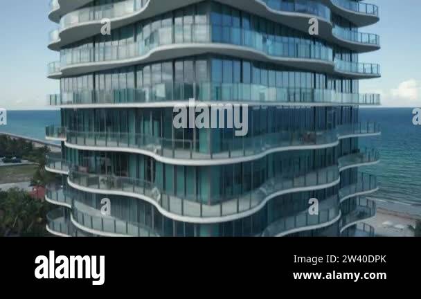 Vertical 4K aerial of modern blue glass building architecture, Miami ...