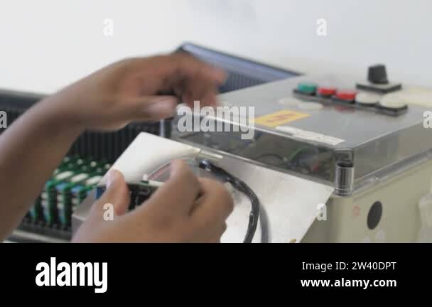 assembling of circuit boards. worker checks boards on errors Stock ...