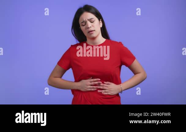 Woman squeezing belly with hands because of abdominal pain. Lady ...