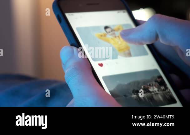 Man using smartphone scrolling through social network feed, doing swiping, scrolling gestures ...