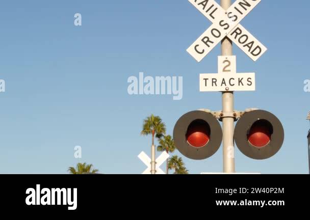 Level crossing warning signal in USA. Crossbuck notice and red traffic ...