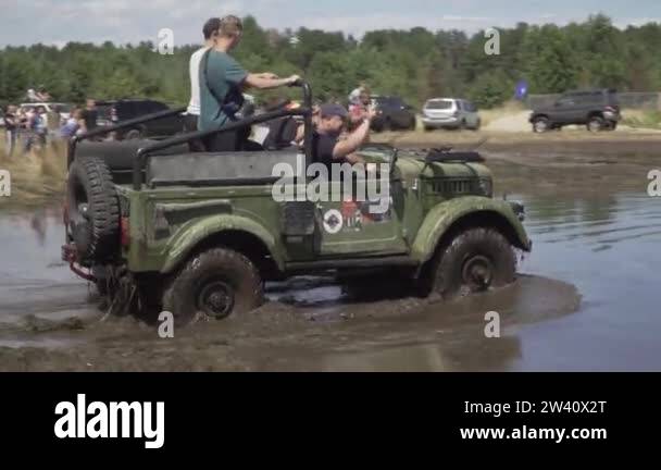 Festival of off-road lovers. SUVs drive the swamp. Cars skid in the mud ...