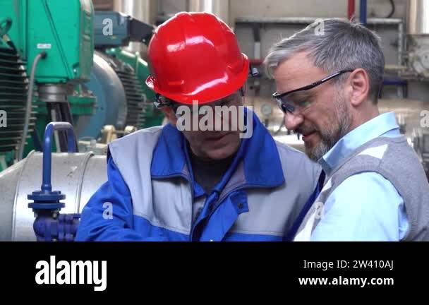 Technical Manager With Digital Tablet Talking to Machine Operator ...