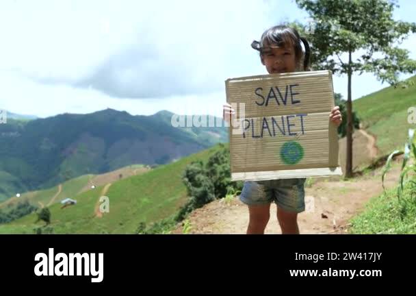 Child girl holding "Save the planet" Poster showing a sign protesting ...