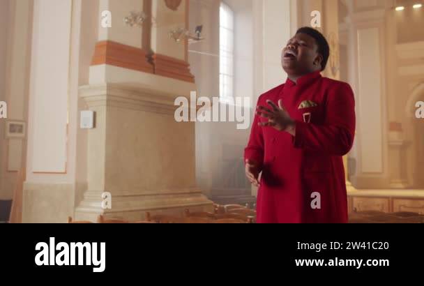 Young afro american emotional singer performing worship music. Male ...