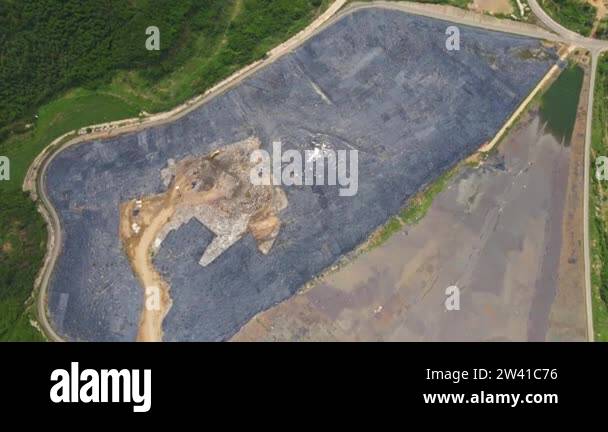 Aerial top view video of a solid waste landfill. City waste treatment ...