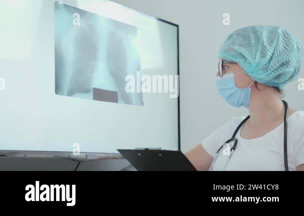 female doctor therapist examines the fluorography. woman pulmonologist ...