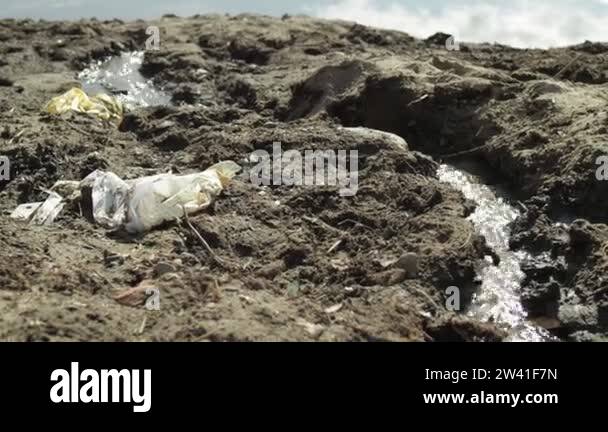 dirty water with waste flows into the river. dirt and silty discharge ...