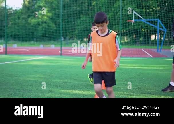 Front view of confident purposeful teen boys in football uniforms which ...