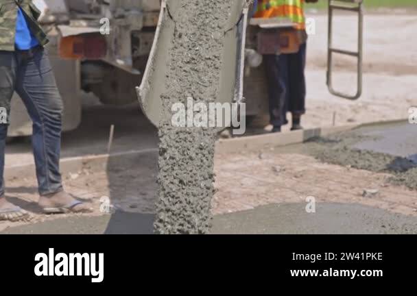 Concrete flowing and pouring from mixer cement truck pours liquid ...