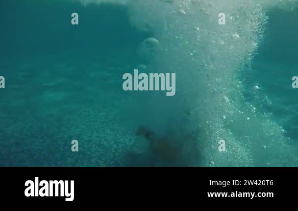 Jolly boy jumping feet first in pool and showing thumb up gestures in ...