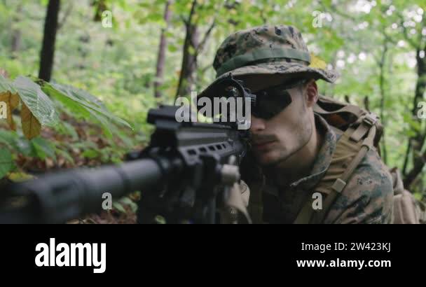 modern warfare soldier in action aiming at weapon laser sight optics in ...