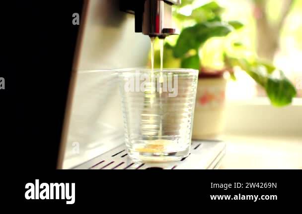 Hot water flows from the coffee maker, one cup portafilter. An ...