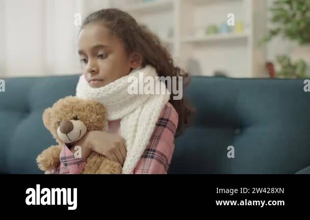 Sick little girl wrapped in scarf coughing, hugging teddy bear, health ...