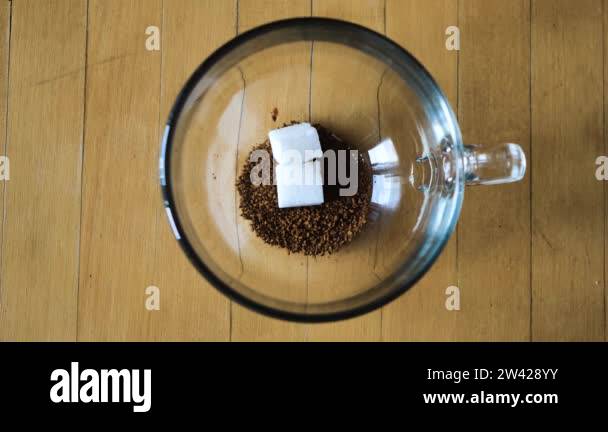 Close-up of process of brewing instant coffee in cup. Concept. Top view ...