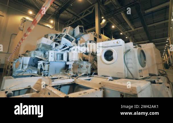 Old washing machines piles at recycling center. Plastic trash at garbage recycling factory Stock ...