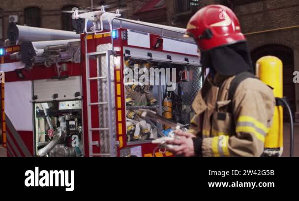 Portrait of firefighter using drone holding control panel in hands to ...