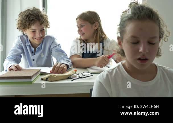 Two teens scoff at their defenseless classmate. Child cruelty. School ...