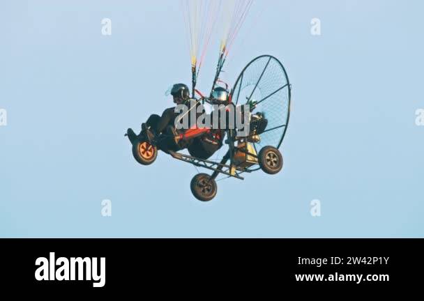 Tandem Paramotor Gliding - two men flying and gliding in the air Stock ...