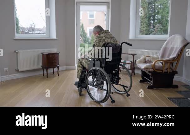 Wide shot back view of motivated grey-haired military veteran trying to ...