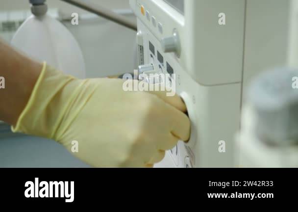 Medical worker adjusting and tuning artificial lung ventilation ...