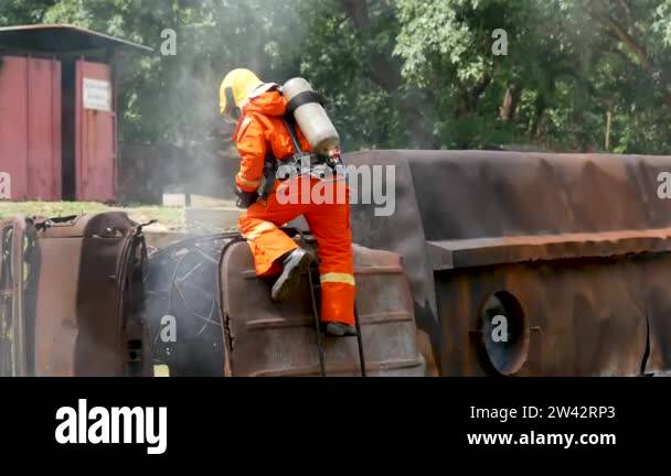 Firefighter fighting with fire flame protection property. Fireman wear ...