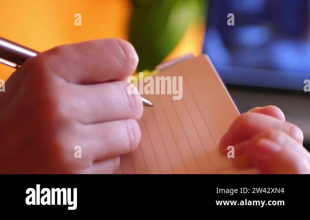 Psychology online session. Close up drawing sad face in notebook ...