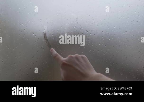 drawing of a sad face on the fogged glass. a symbol of happy mood and ...
