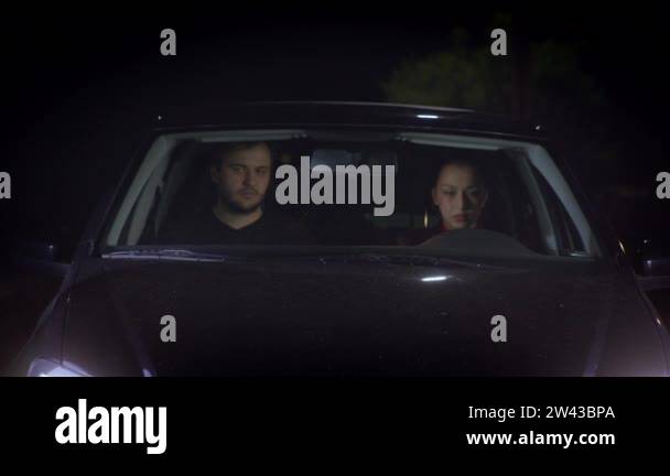 Young couple inside car in night trip before car accident on road, car ...