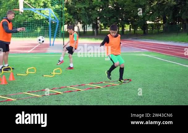 Portrait of persistent active teen boys in football uniforms which ...