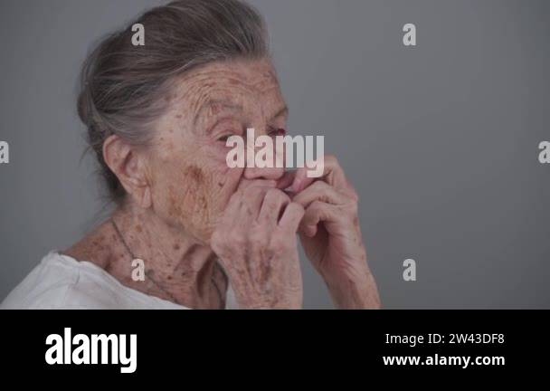 Problem of teeth in old age. Senior woman fitted denture in studio on ...