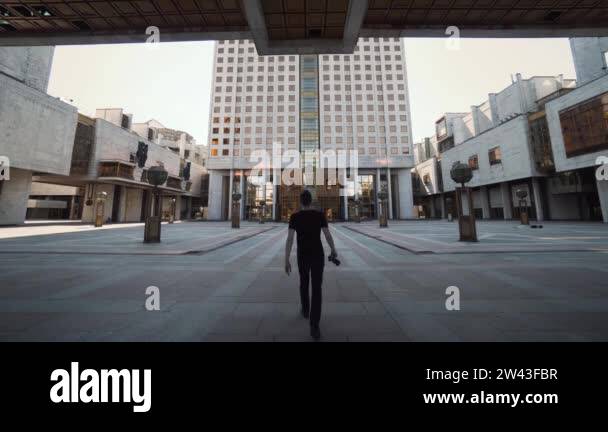 Man photographs beautiful modern building in city. Action. Professional ...