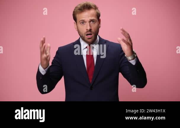 shocked elegant businessman opening mouth, covering face with palms, looking up and asking why ...