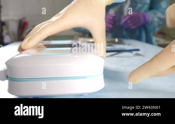 Assistant at work in dental clinic. surgical instruments are being ...