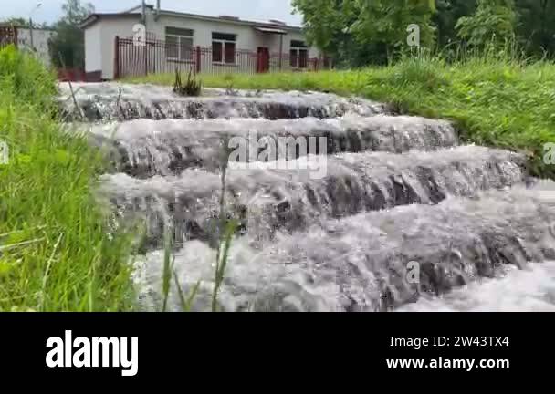 Water runs down the steps against the background of the building. Rain ...