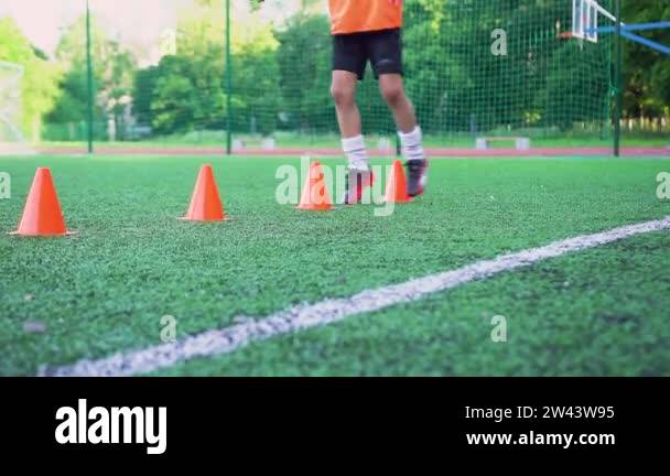 Purposeful sporty teen boy doing running exercises with racks that are ...