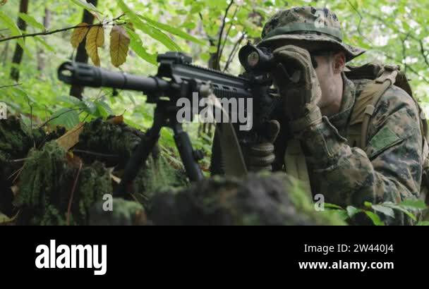 Fully equipped rifle soldier wearing camouflage uniform attacking enemy ...
