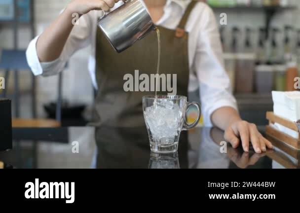 Barista concept. Woman making tea at a bar in a coffee shop. 4k ...
