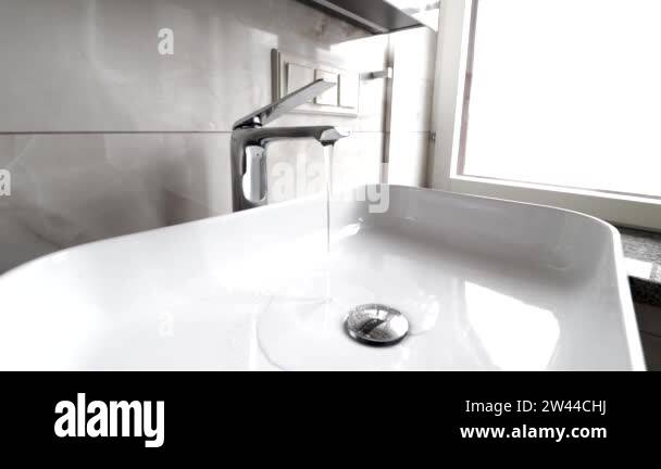 Water flows from the tap . White shell. The interior of the bathroom ...