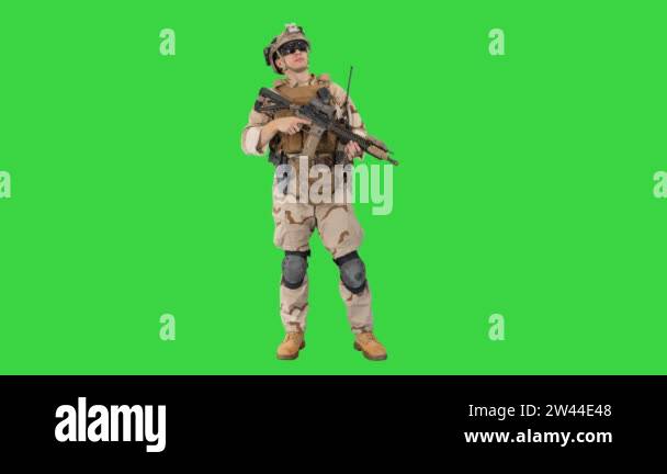 Tired american soldier with a rifle standing on a Green Screen, Chroma ...